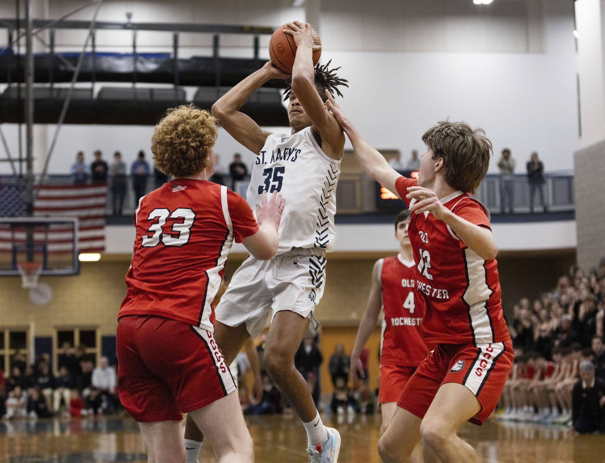 Omri Merryman rises above a swarm of Old Rochester players for the shot ...